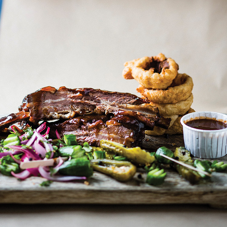 Smoked giant beef ribs with beer-battered onion rings and jalapeno ...