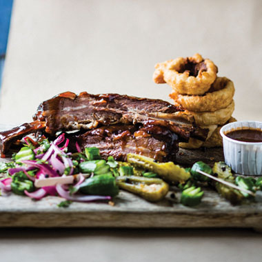 Smoked giant beef ribs with beer-battered onion rings and jalapeno ...